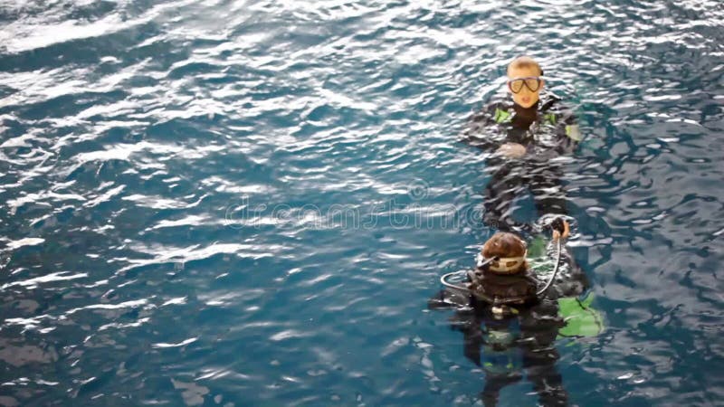 Two Divers Float on Water Surface in Swimming Stock Footage - Video of ...