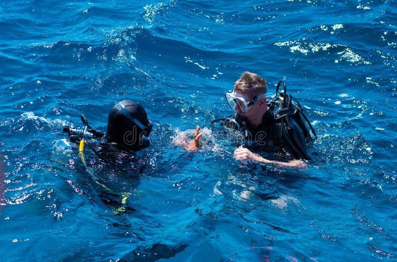 Divers on the Surface of Water Ready To Dive Stock Image - Image of ...