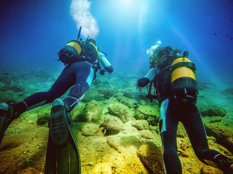 Two Divers Swimming Away from Camera. Stock Image - Image of lifestyle ...