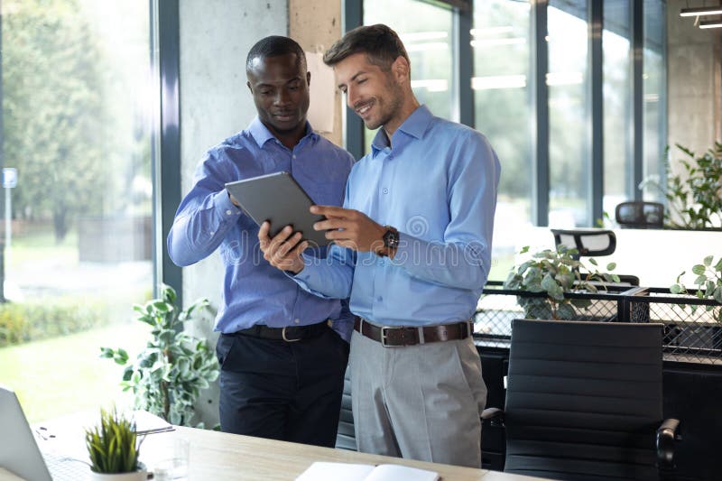 Two Diverse Business Partners Standing and Discussing Project Working ...