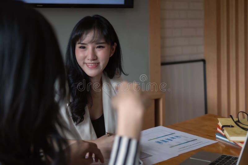 Two Diverse Businesswomen Discussing Business Project Working Together