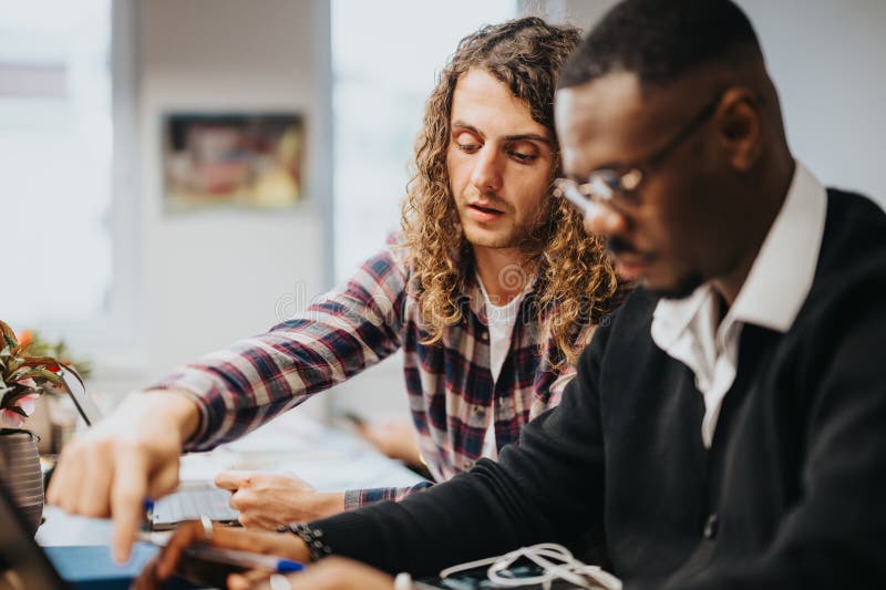 Two Diverse Colleagues Brainstorming Over a Project in a Bright Office ...