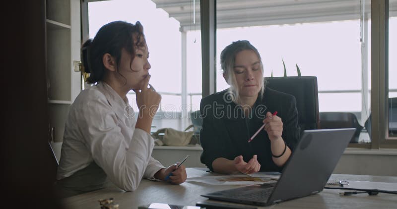 Diverse Colleagues Collaborate on a Project in a Modern Office Using ...