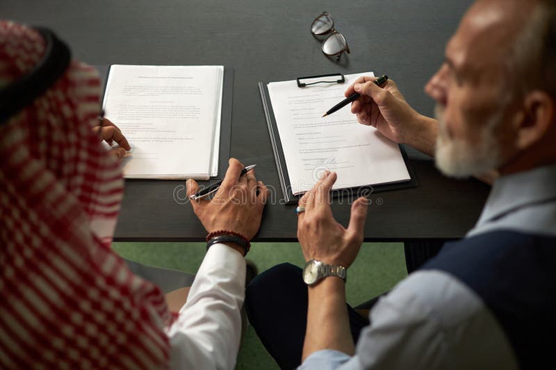 Two Diverse Colleagues Discussing Agreement Document Stock Photo ...