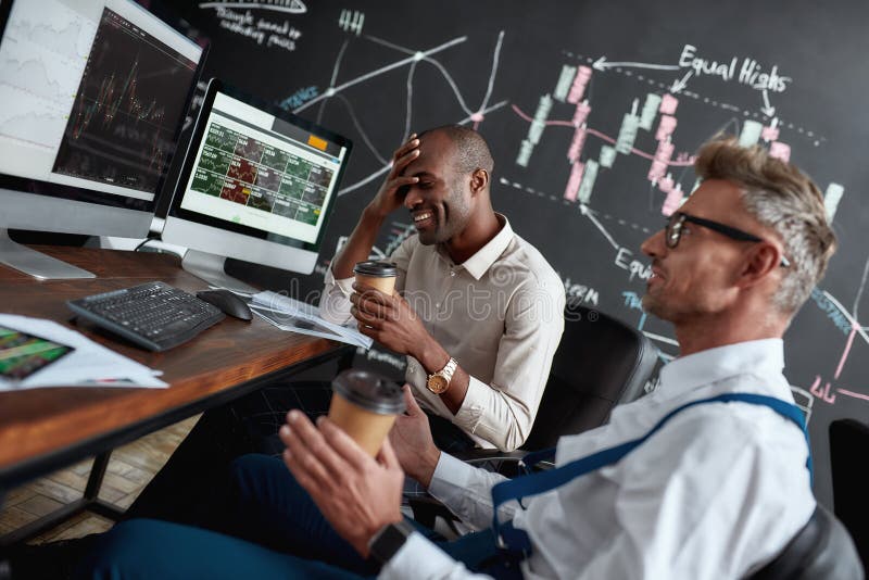 Earn Better. Two Diverse Colleagues Traders Discussing Ideas while ...