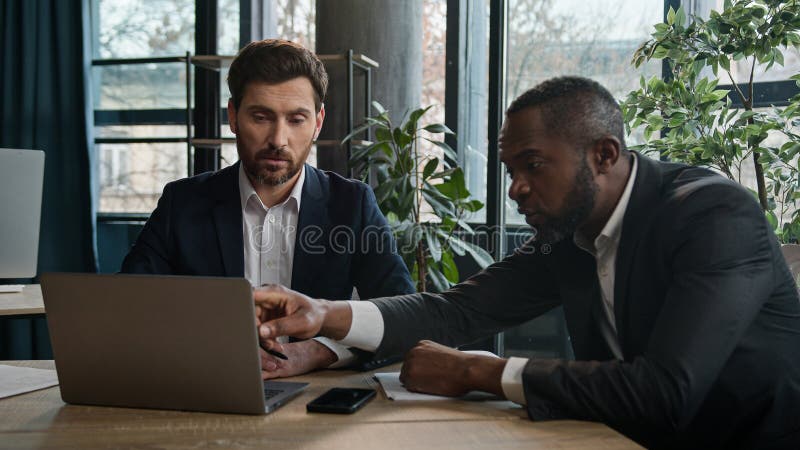 Two Diverse Multiracial Businessmen Discuss Online Data Project with ...