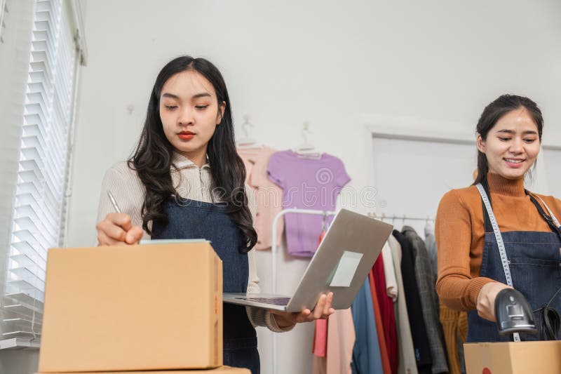 Two Diverse Retail Workers Managing Inventory and Organizing Clothing ...