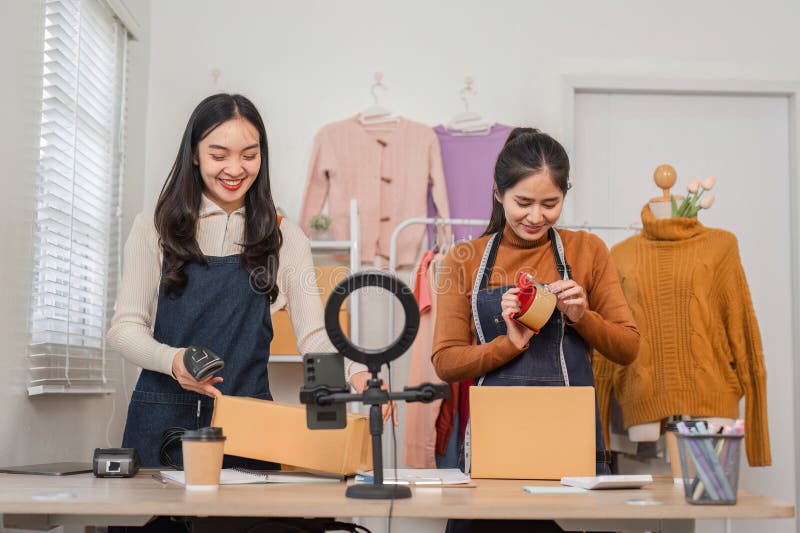 Two Diverse Retail Workers Smiling while Packing Boxes and Preparing ...