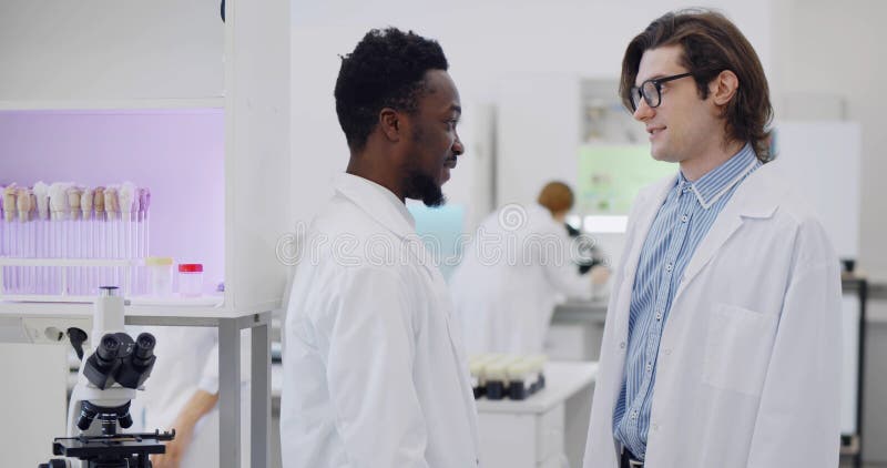 Two Diverse Scientists Working Together Analyzing Discussing Innovative ...