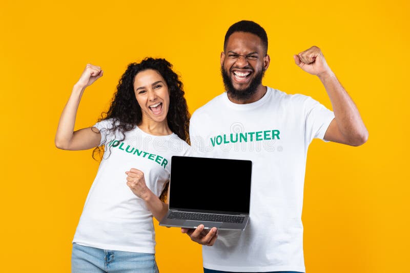 Two Diverse Volunteers Showing Laptop Screen Gesturing Yes, Yellow ...