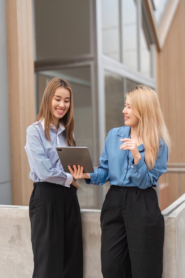 Diverse Women Sharing Information on a Tablet, Showcasing Teamwork and ...