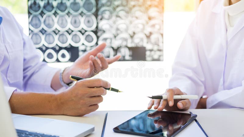 Two Doctors Analyzing a Scan or X-ray Film or Explains a CT Sca Stock ...