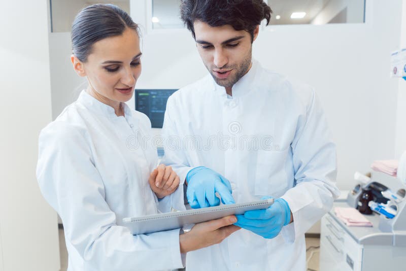 Two Doctors As Team Looking at Tablet Computer Data Stock Image - Image ...