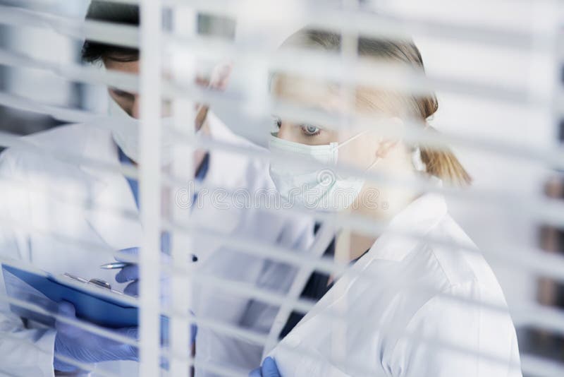 Pair of Doctors Behind the Blinds of Stock Image - Image of mask ...