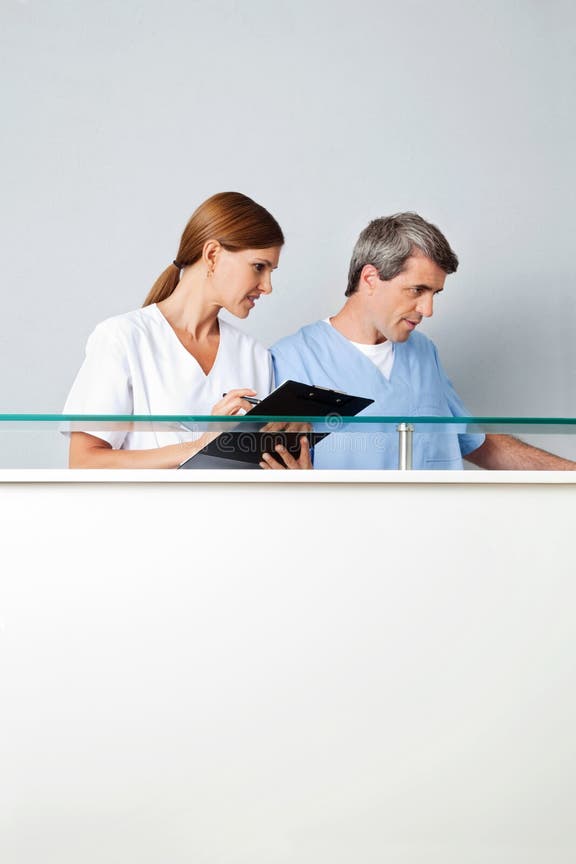 Two Doctors Behind the Counter Stock Image - Image of clinic, disposal ...