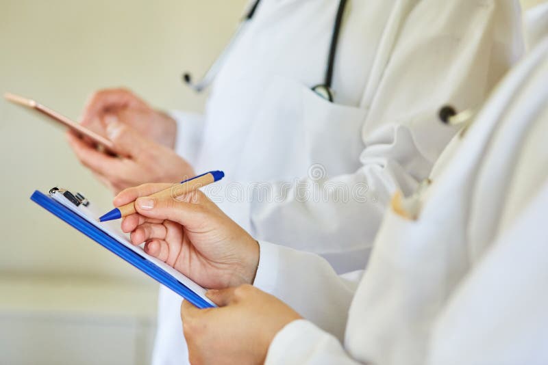 Two Doctors with Clipboard and Tablet Computer Stock Image - Image of ...