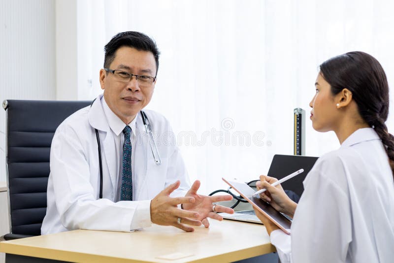 Two doctors discussing stock photo. Image of nurse, computer - 136232332