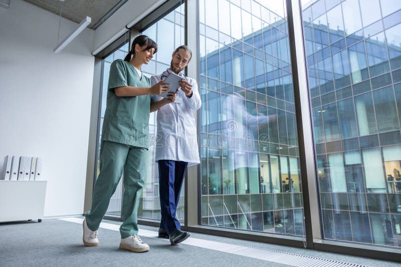 Two Doctors Discussing an Interesting Case while Walking in the Clinic ...