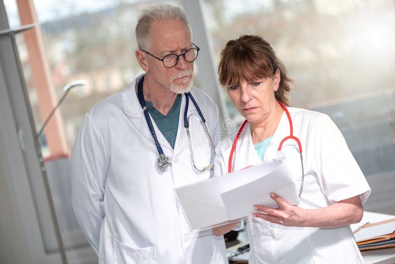 Two Doctors Discussing about Medical Report Stock Photo - Image of ...