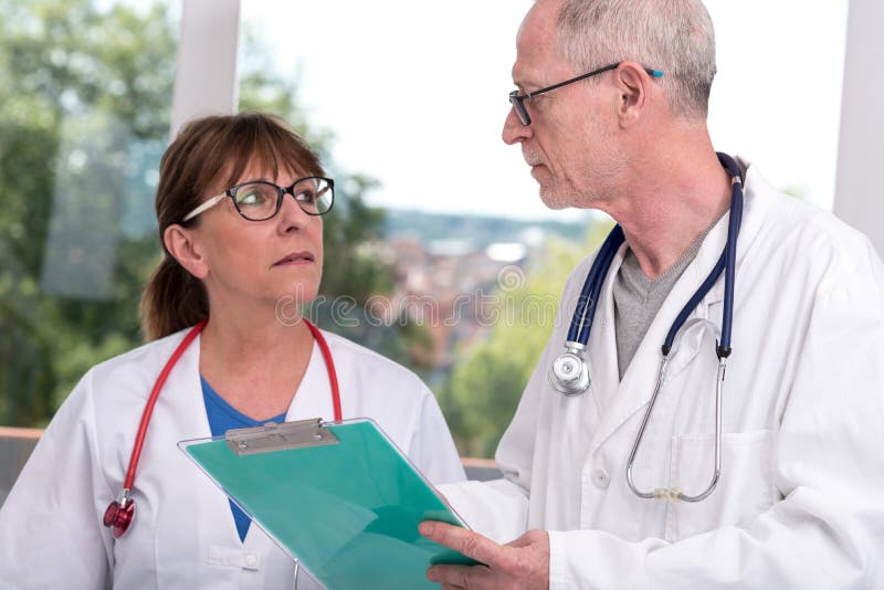 Two Doctors Discussing about Medical Report Stock Image - Image of ...