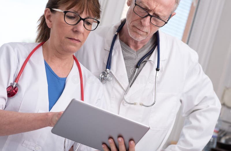 Two Doctors Discussing about Medical Report on Tablet Stock Photo ...
