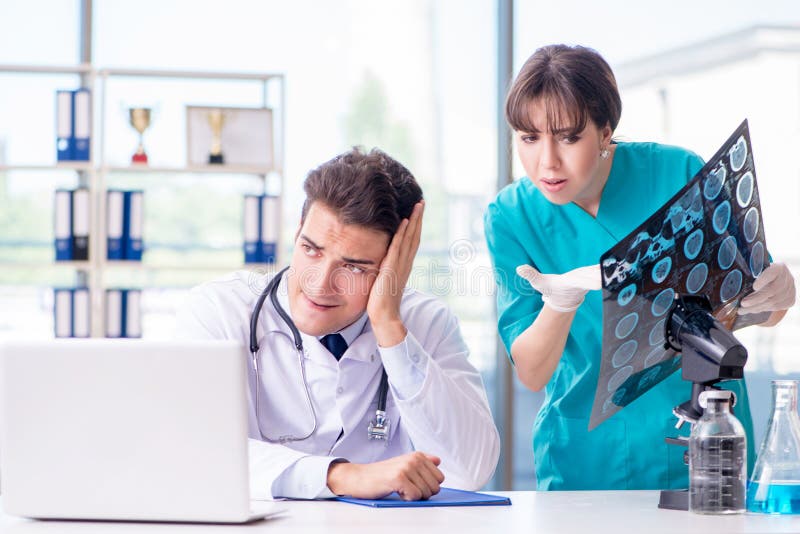 The Two Doctors Discussing X-ray Mri Image in Hospital Stock Image ...