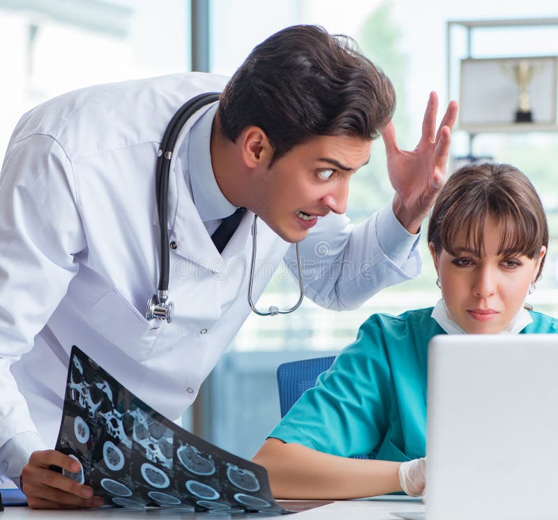 Two Doctors Discussing X-ray MRI Image in Hospital Stock Image - Image ...
