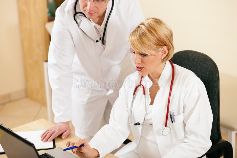 Two Doctors Discussion Documents or Test Results Stock Image - Image of ...
