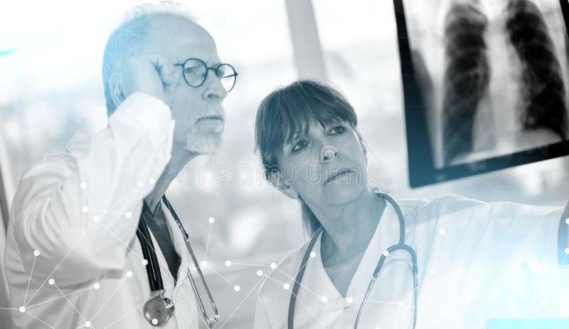 Two Doctors Examining X-ray Report; Light Effect Stock Image - Image of ...