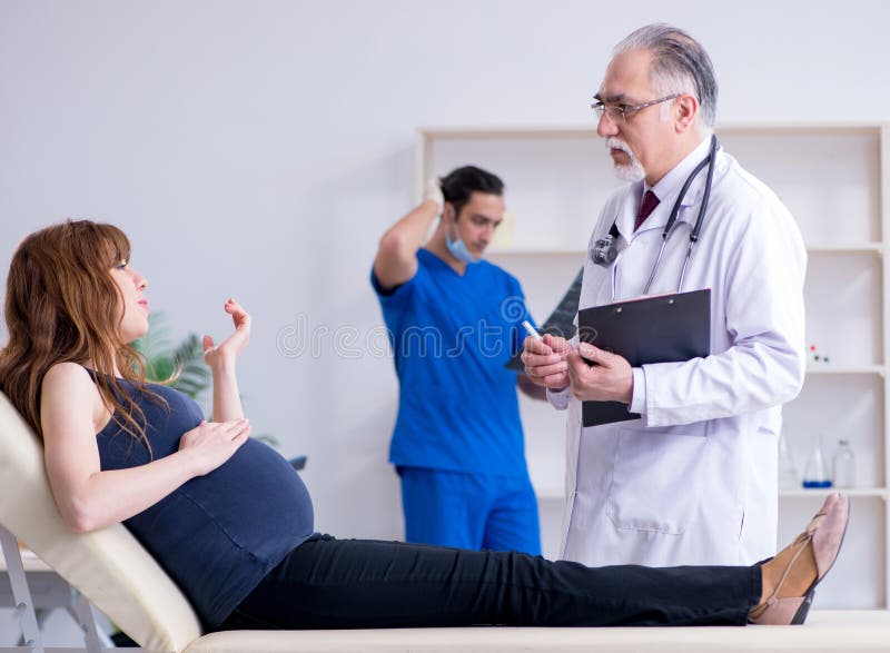 Two Doctors Examining Young Woman Stock Photo - Image of checking ...