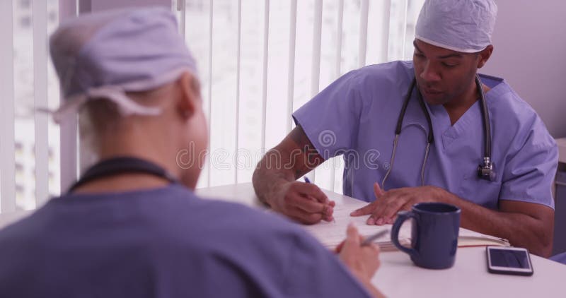 Two Doctors Filling Out Paperwork Stock Footage - Video of practitioner ...