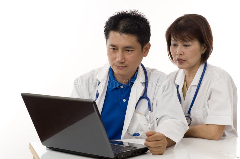 Two Doctors Looking at Computer on Their Desk Stock Photo - Image of ...