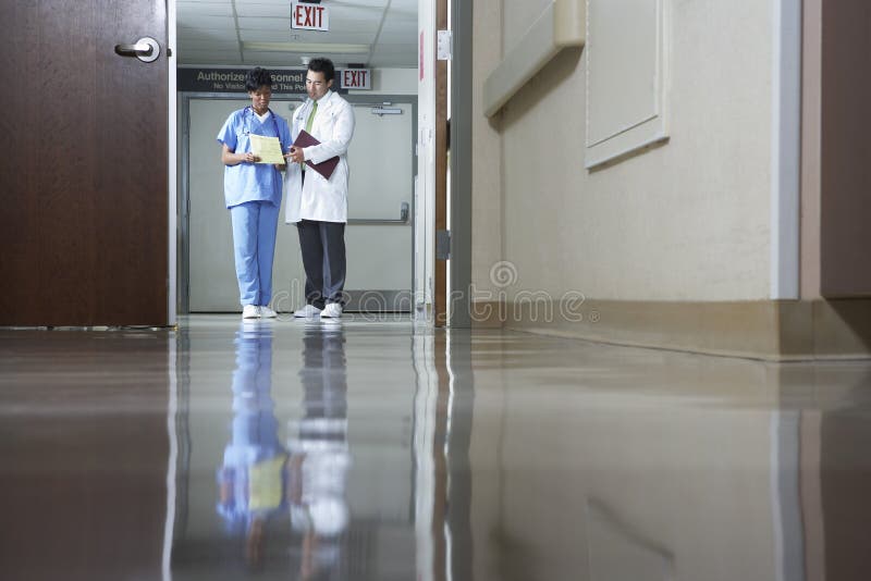 Two Doctors Discussing Medical Results of Patient in Hospital Stock ...