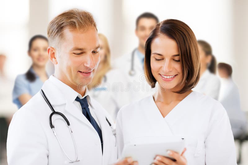 Two Doctors Looking at Tablet Pc Stock Image - Image of doctors ...
