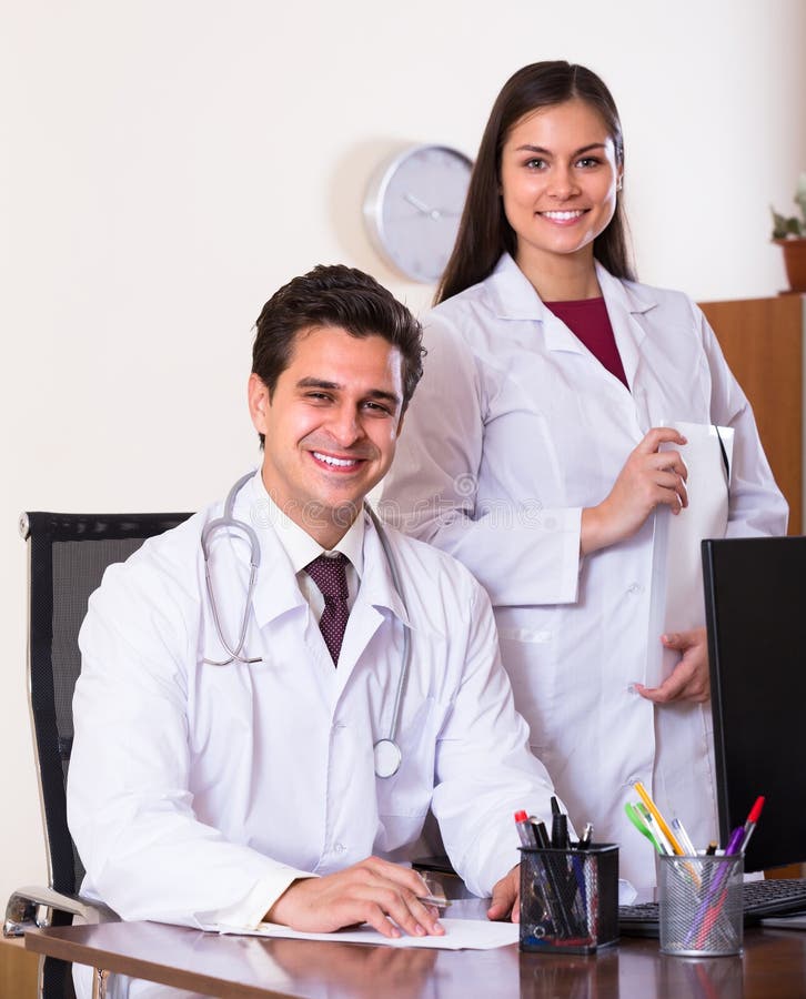 Two Doctors in Private Clinic Stock Photo - Image of desk, paramedics ...