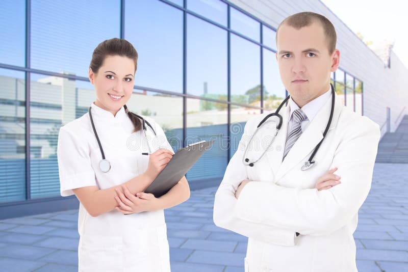Two Doctors Standing Against Modern Hospital Building Stock Photo ...