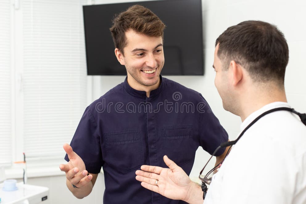 Two Doctors Talking with Each Other in Hospital Stock Photo - Image of ...