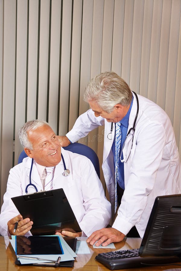 Two Doctors Talking in Hospital Office Stock Photo - Image of citizens ...