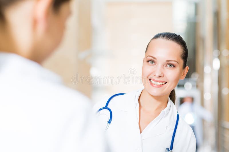 Two Doctors Talking in the Lobby Stock Image - Image of environment ...