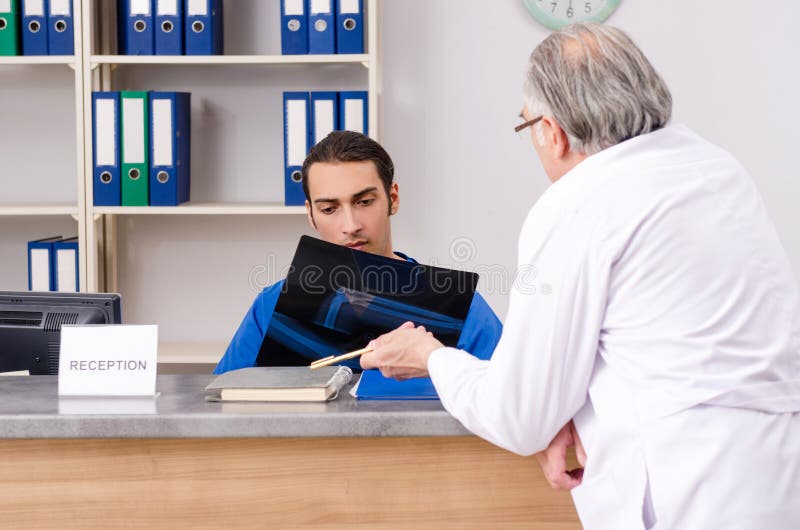 Two Doctors Talking at the Reception in Hospital Stock Image - Image of ...