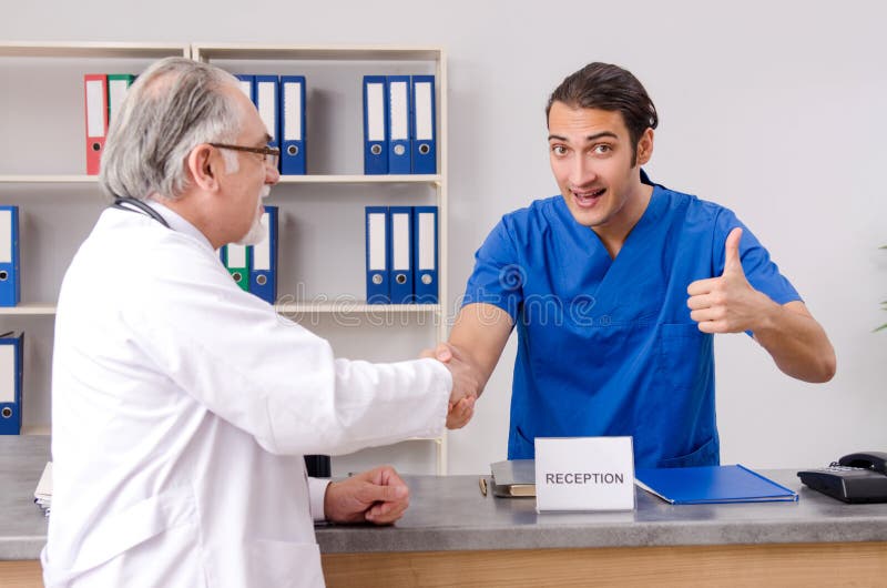Two Doctors Talking at the Reception in Hospital Stock Photo - Image of ...