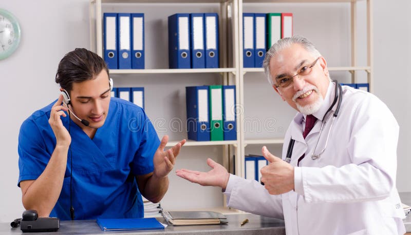 Two Doctors Talking at the Reception in Hospital Stock Photo - Image of ...