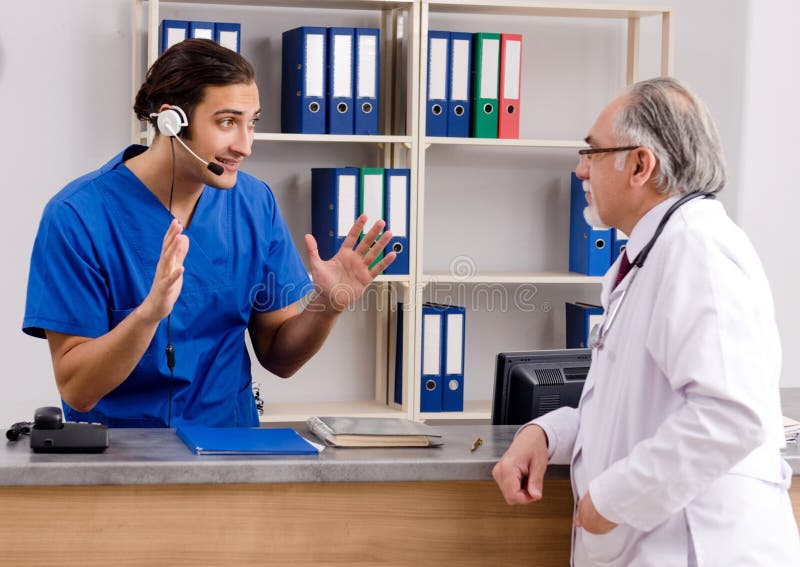 Two Doctors Talking at the Reception in Hospital Stock Image - Image of ...