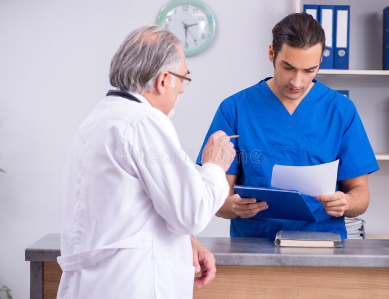 Two Doctors Talking at the Reception in Hospital Stock Photo - Image of ...