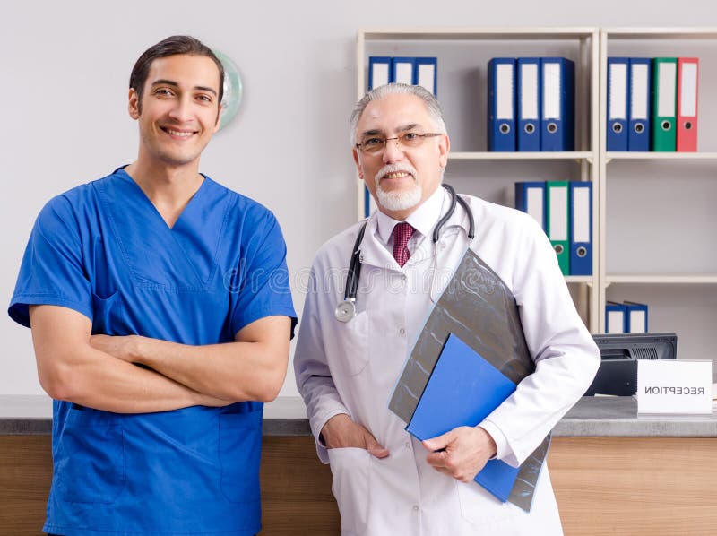 Two Doctors Talking at the Reception in Hospital Stock Image - Image of ...