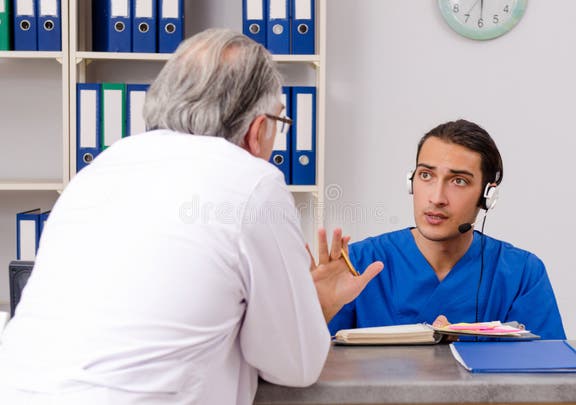 Two Doctors Talking at the Reception in Hospital Stock Photo - Image of ...