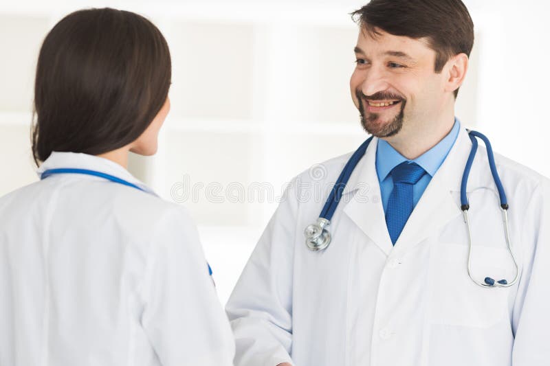 Two doctors talking stock photo. Image of discussing - 269736374