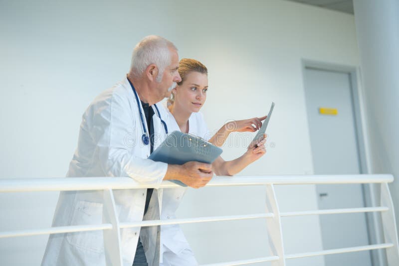 Two Doctors Talking To Each Other in Hospital Stock Photo - Image of ...