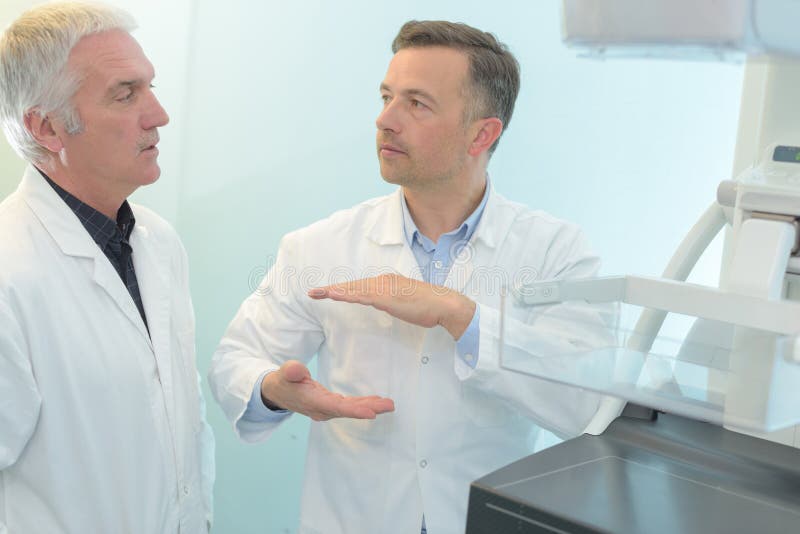 Two Doctors Talking To Each Other in Hospital Stock Photo - Image of ...