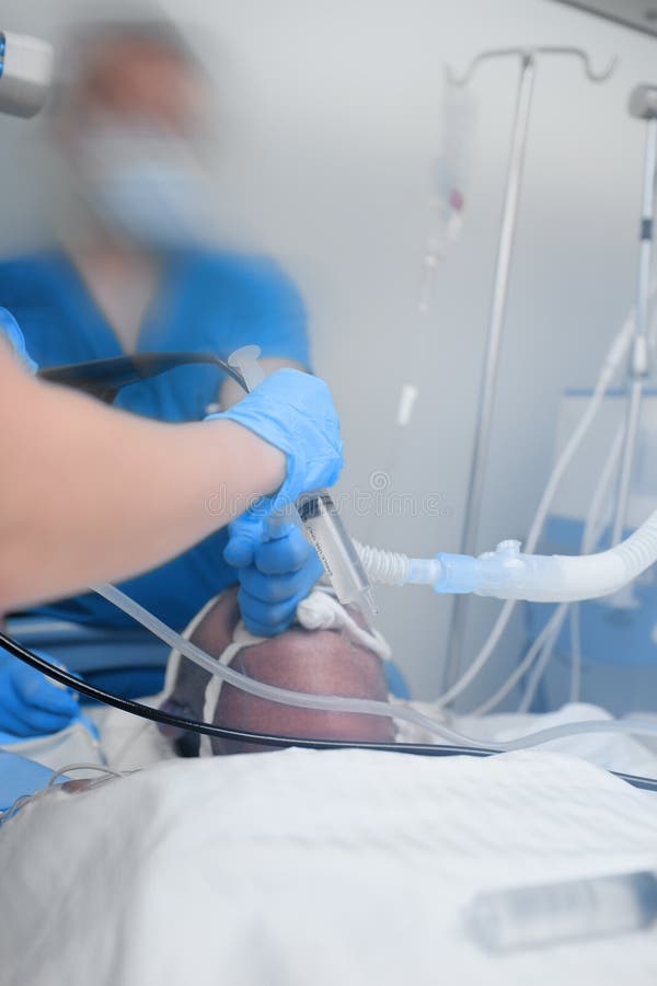 Two Doctors during Therapeutic Procedure To the ICU Patient Stock Photo ...